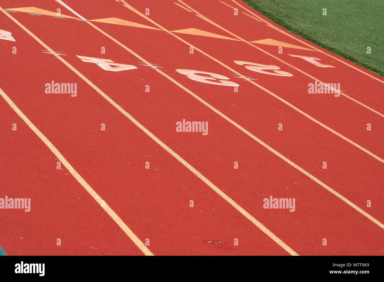 Red running track lanes Stock Photo - Alamy
