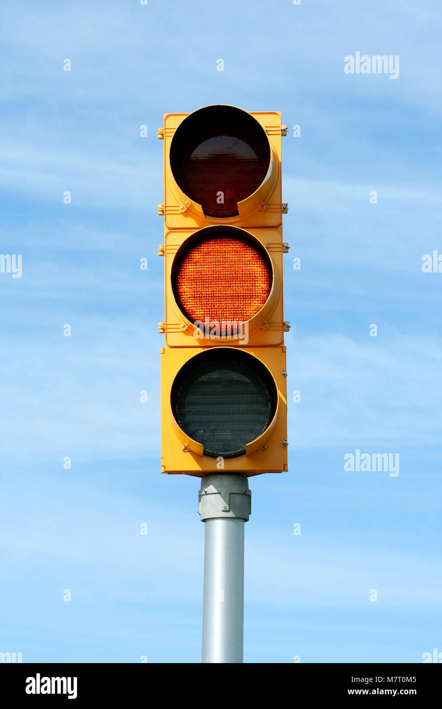 Yellow traffic signal light against blue sky Stock Photo - Alamy
