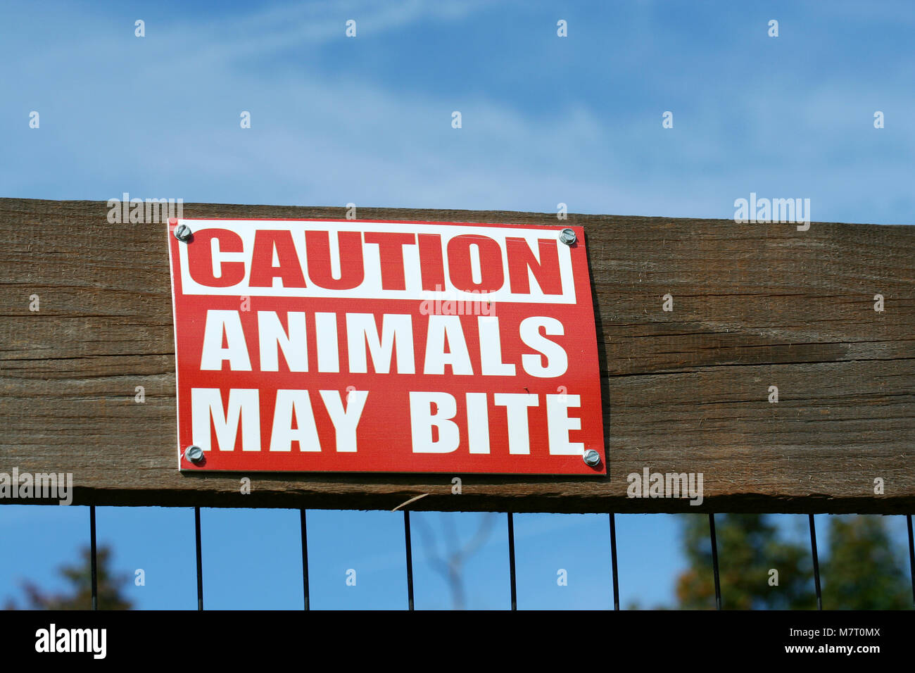 Caution animals may bite sign on a fence Stock Photo - Alamy