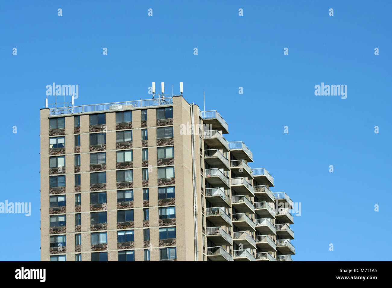 A Hi-rise apartment building against blue sky Stock Photo - Alamy