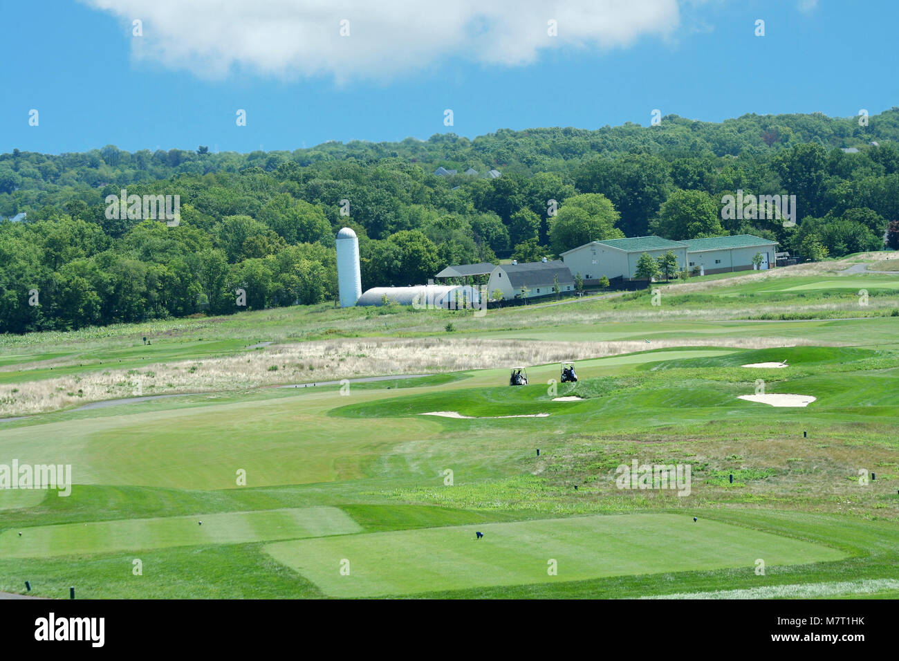 A Golf course with farm in the background Stock Photo - Alamy