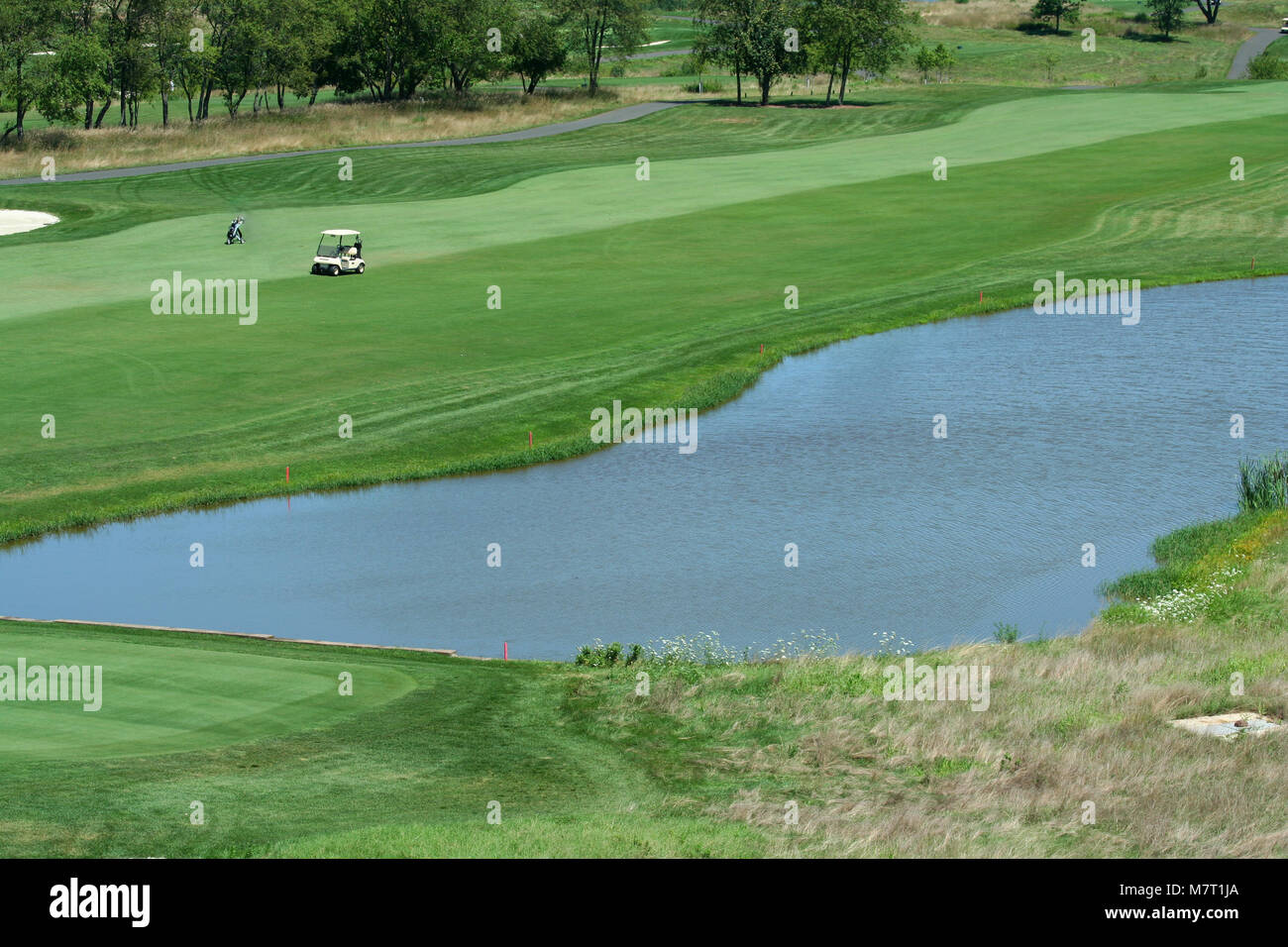 A Golf course fairway with water hazzard Stock Photo - Alamy