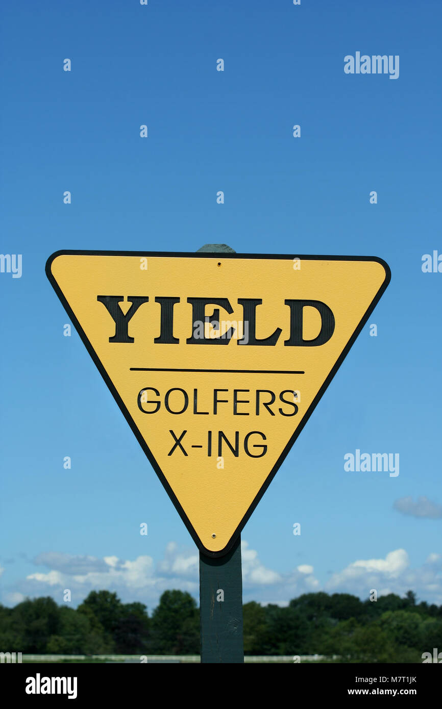 A yellow Yield golfer crossing sign Stock Photo - Alamy