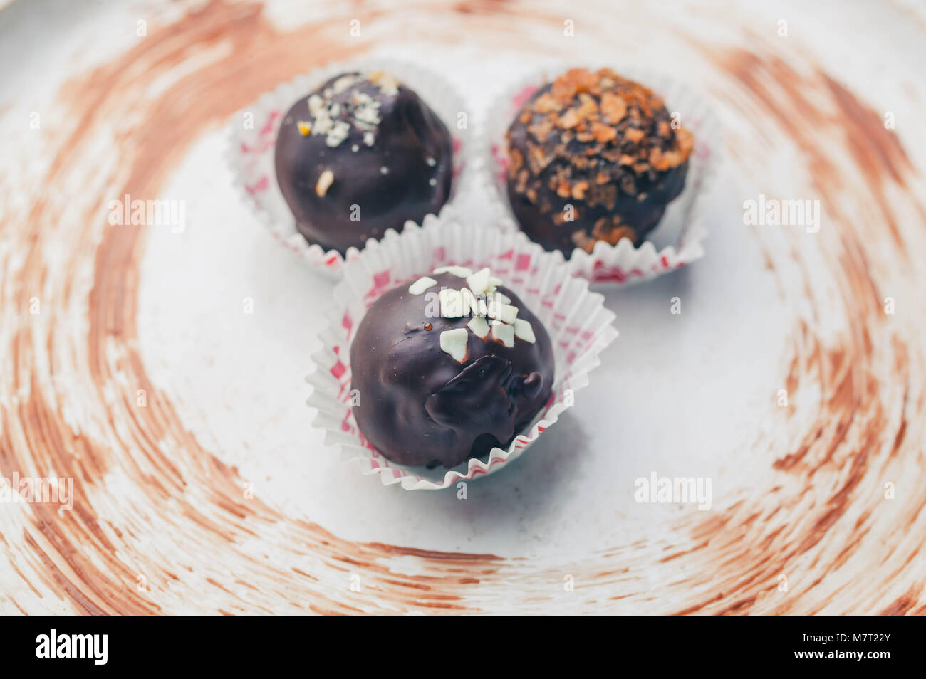 Handmade chocolates with cheese stuffing. white and classical dark ...