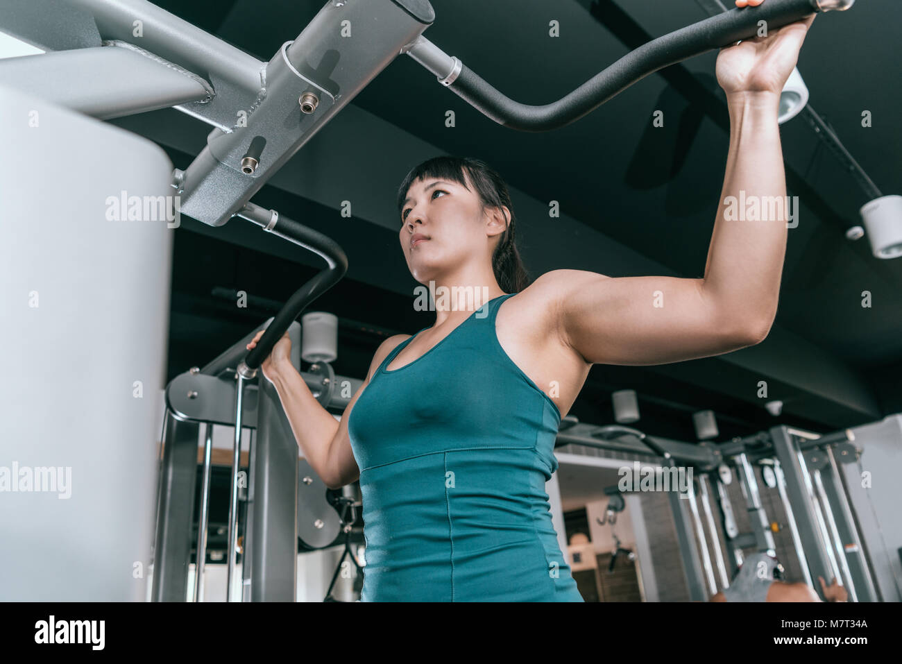 Woman doing pull ups hi-res stock photography and images - Alamy