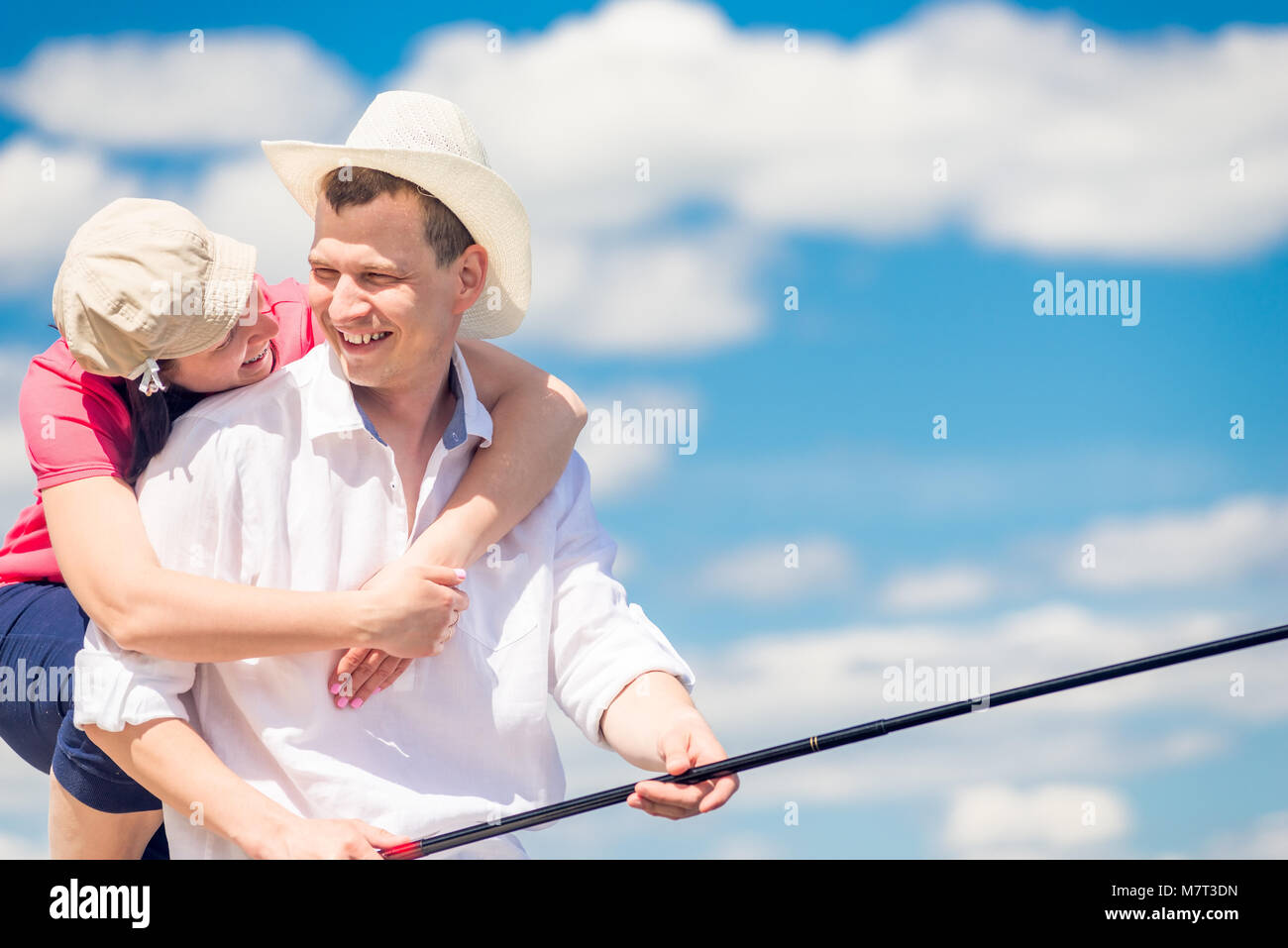 portrait of happy couple on fishing, woman hugging man Stock Photo - Alamy
