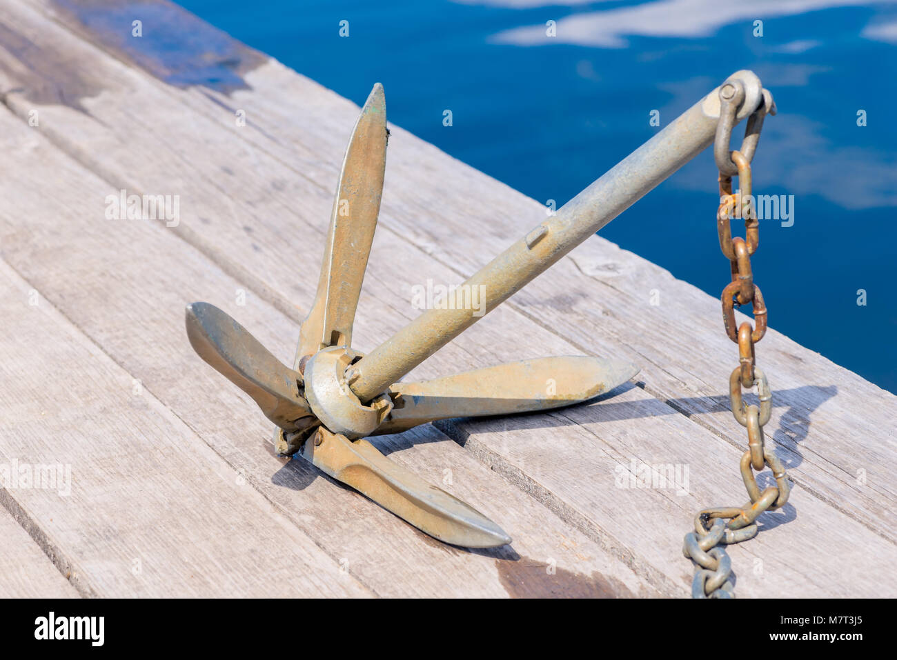 heavy anchor close-up, lying on a wooden pier Stock Photo - Alamy
