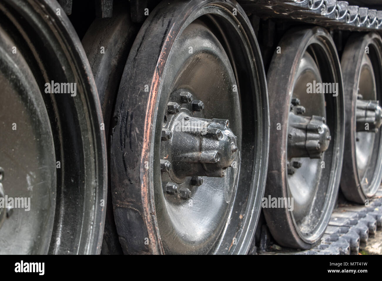 A closeup of tracks of an old tank. The part of tank with a large ...
