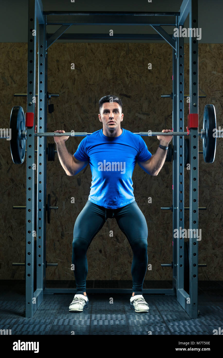 bodybuilder with a barbell in the gym is practicing Stock Photo - Alamy