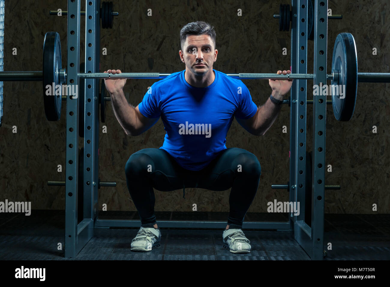 cute young bodybuilder with a barbell in the gym is practicing Stock ...