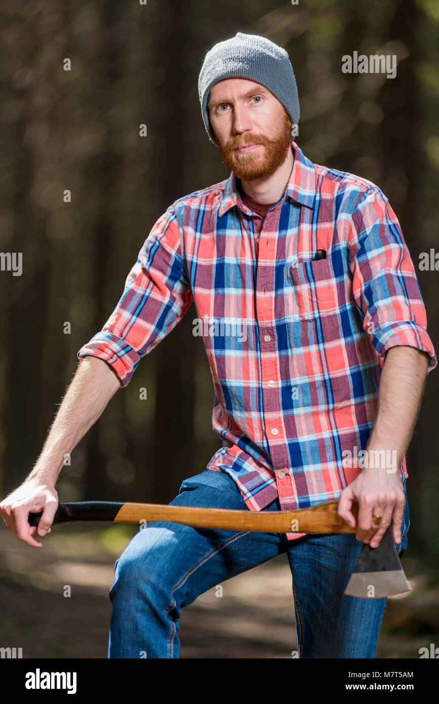portrait of a man in a plaid shirt with an ax in the forest Stock Photo ...