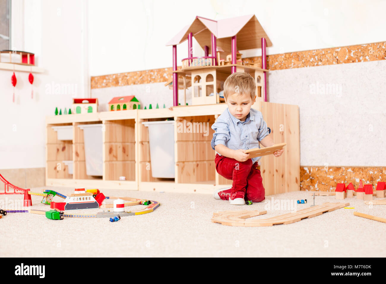 Boy plays with train Stock Photo - Alamy