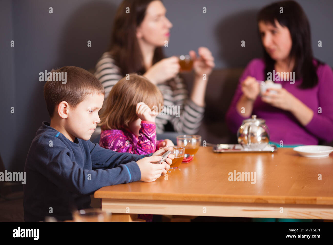 The children at the table Stock Photo - Alamy