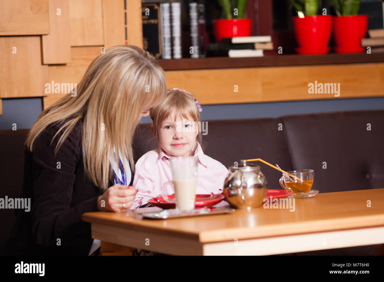 Mom and daughter enjoying life in the cafe Stock Photo - Alamy