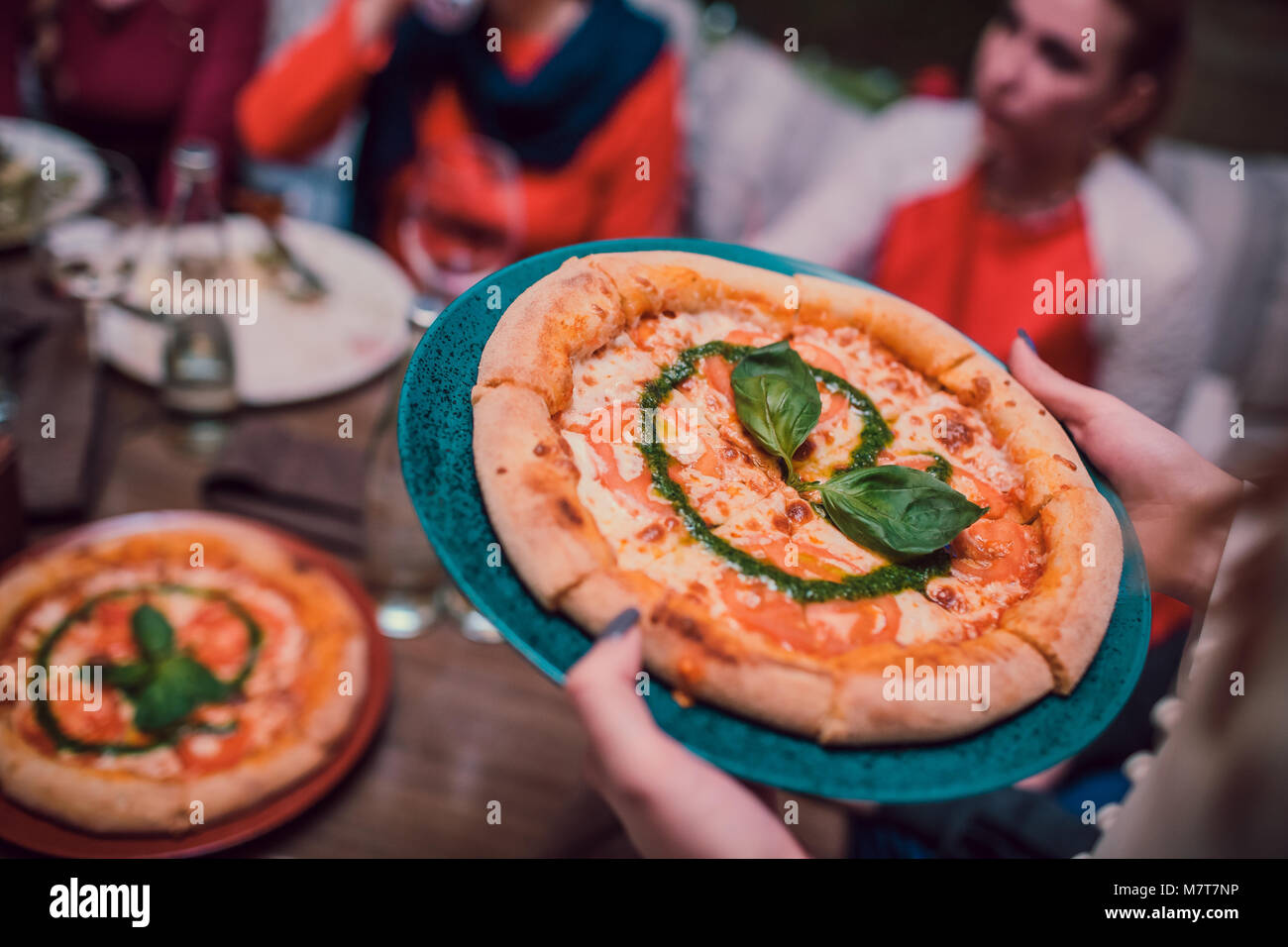 Woman waitress in serving pizza in the restaurant Stock Photo - Alamy