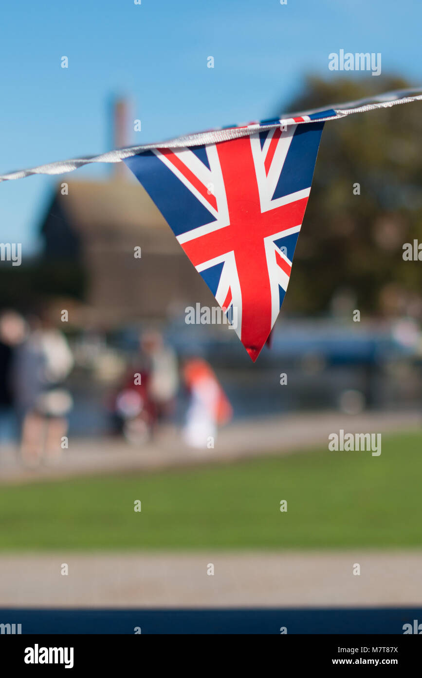 red white and blue union jack bunting with typical British scene in the ...