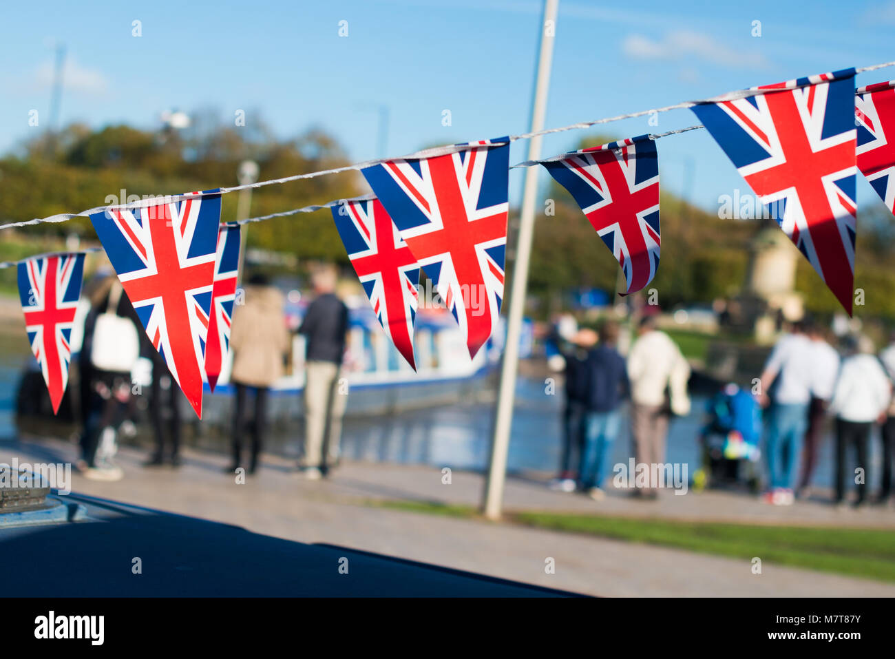 red white and blue union jack bunting with typical British scene in the ...