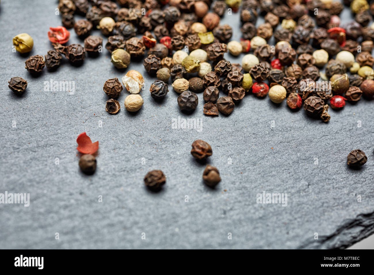 Allspice seeds isolated on dark background. Heap of spice. Mix of ...