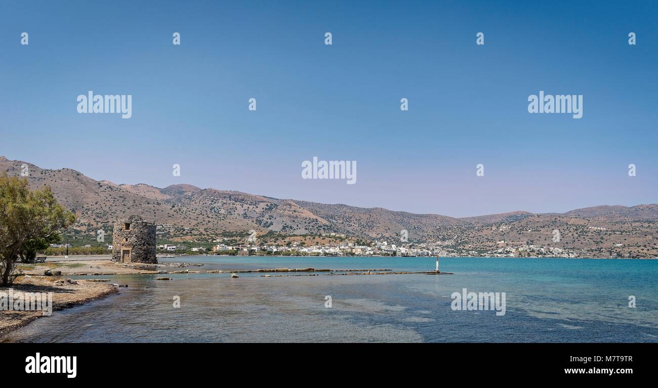 Panorama of the bay at Elounda in Crete. An old windmill is in the ...