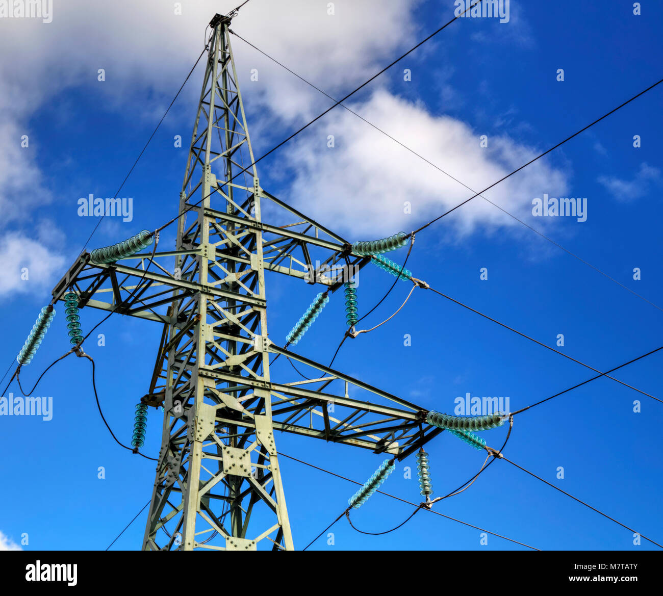High voltage electrical overhead line on blue sky Stock Photo - Alamy
