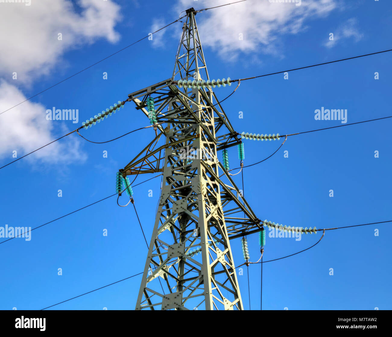 High voltage electrical overhead line on blue sky Stock Photo - Alamy