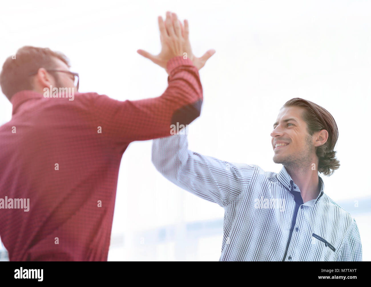 two business men giving each other a high five Stock Photo - Alamy