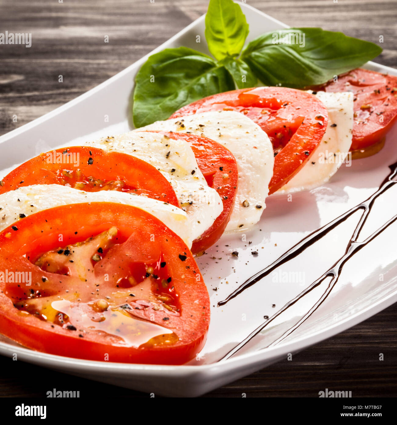Caprese salad on wooden background Stock Photo - Alamy