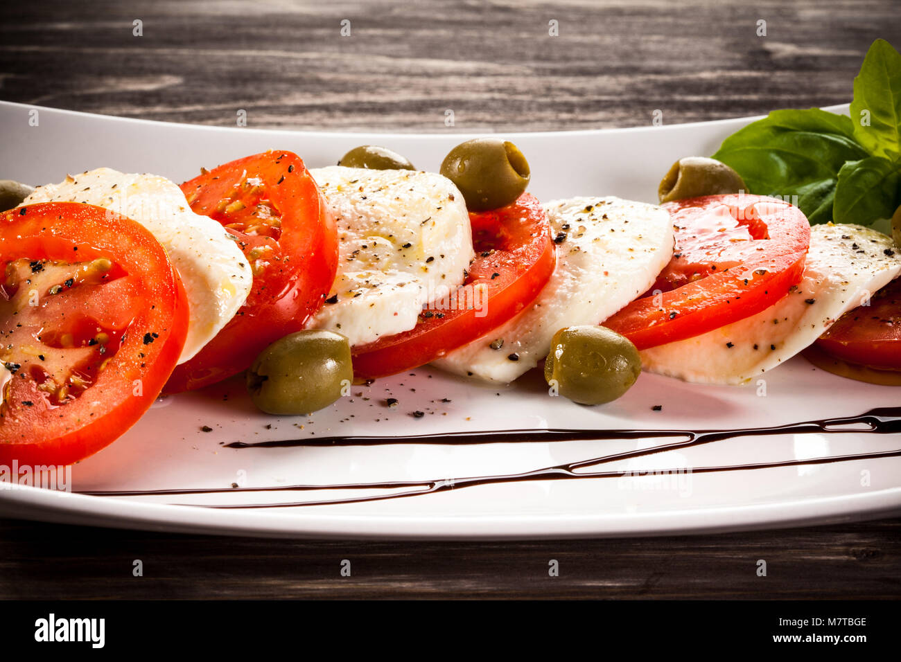 Caprese salad on wooden background Stock Photo - Alamy