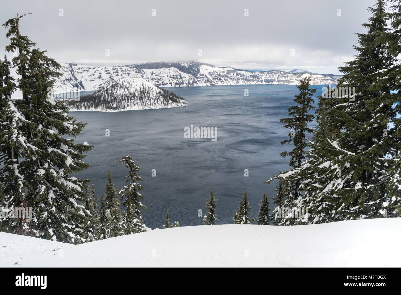 Clouds roll by the north rim at Crater Lake towards Mt Scott in the ...