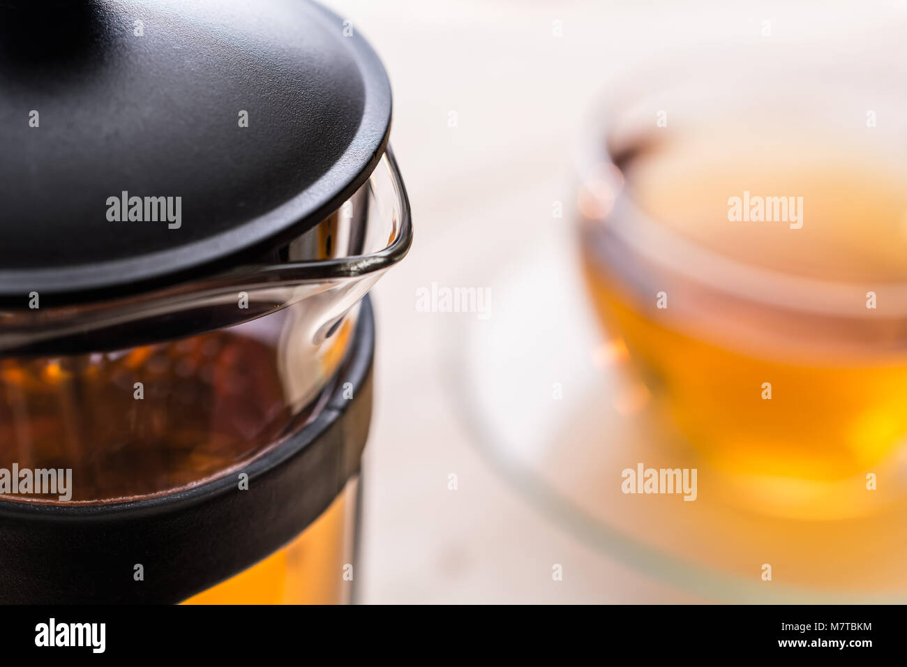 Macro Of A Teapot With A Blurry Cup Of Tea In Background Stock Photo ...