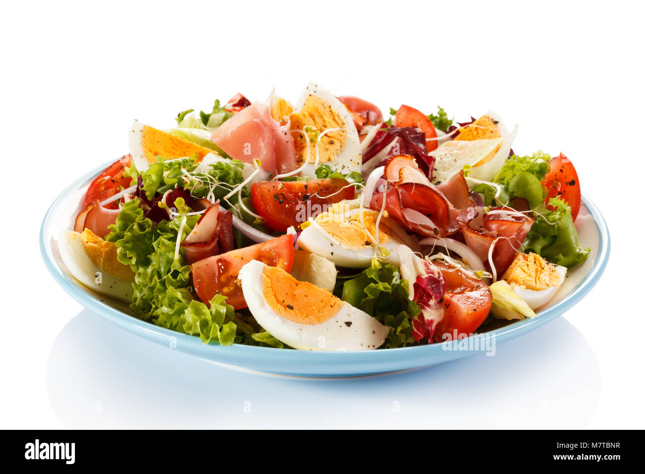 Boiled eggs with smoked ham and vegetables Stock Photo - Alamy