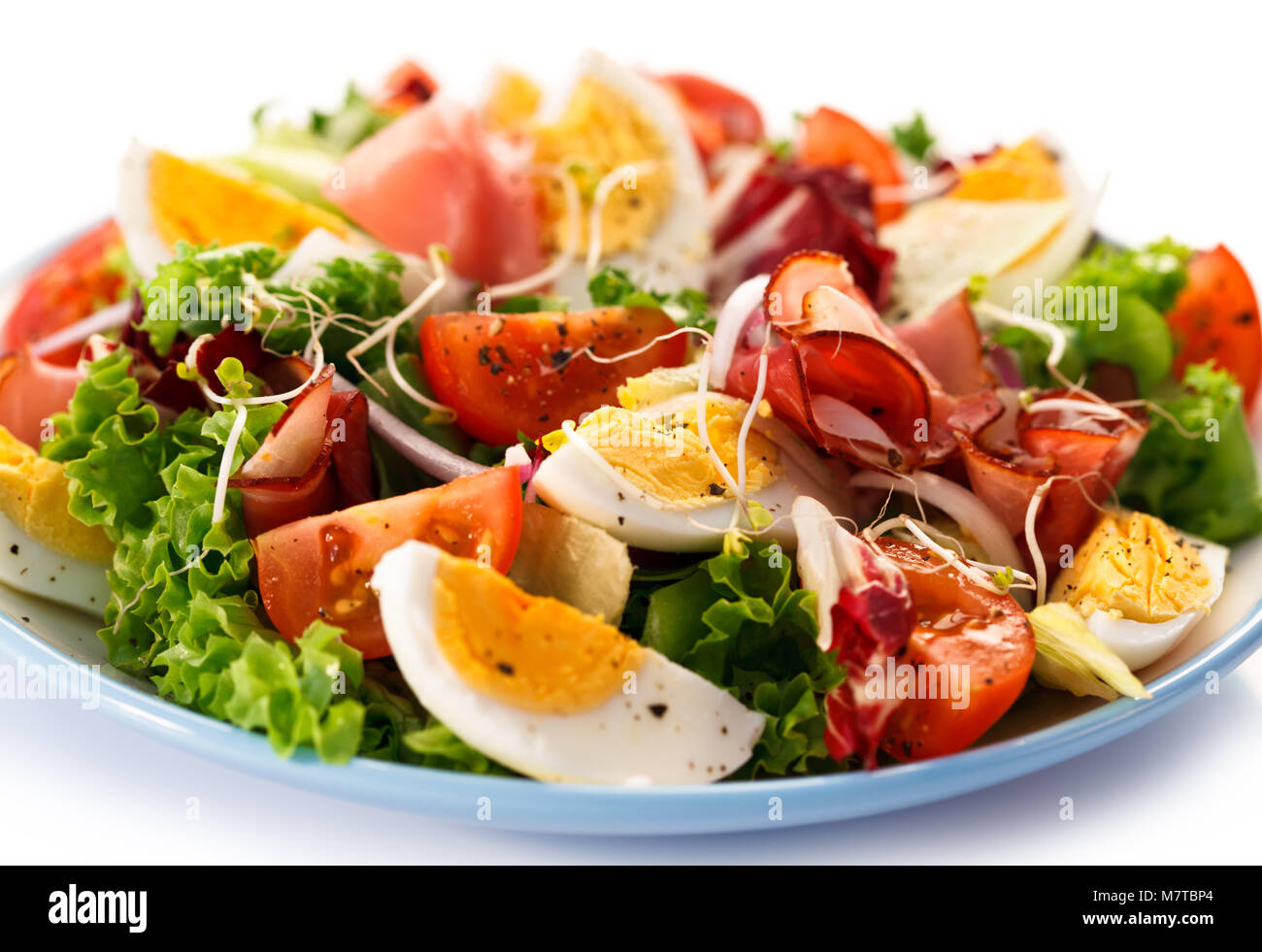 Boiled eggs with smoked ham and vegetables Stock Photo - Alamy