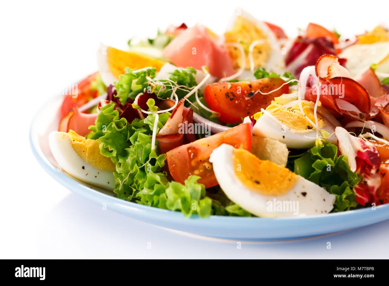 Boiled eggs with smoked ham and vegetables Stock Photo - Alamy