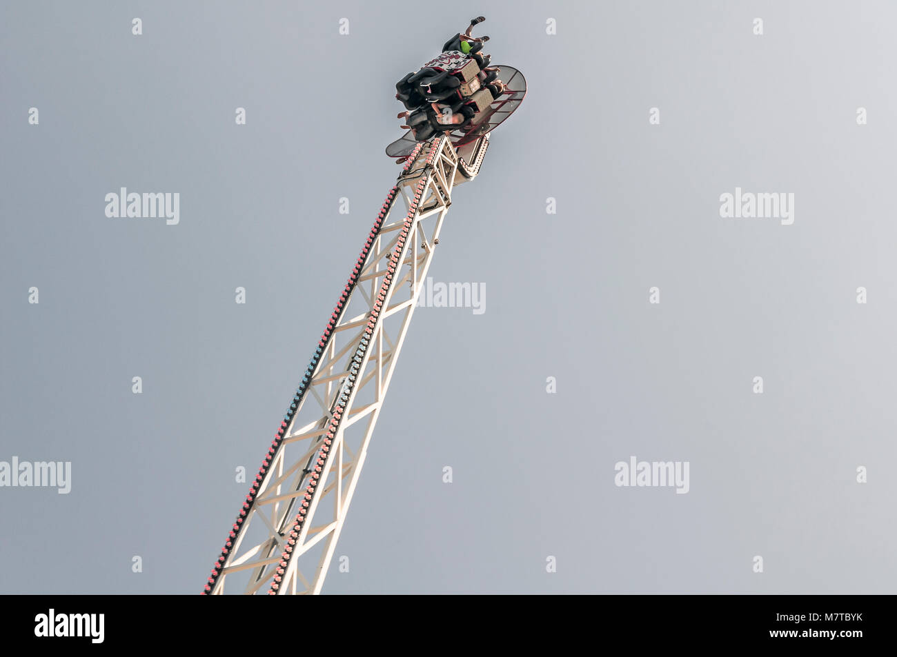 people hanging upside down in a fairground attraction Stock Photo - Alamy
