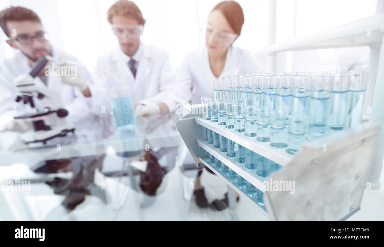 background image of scientists studying blue liquid in a flask Stock ...