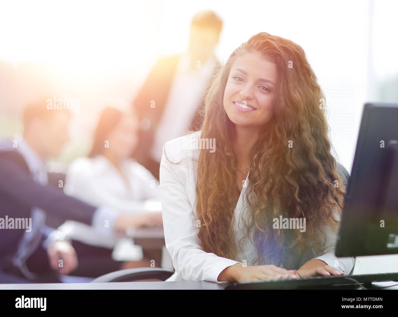 Manager woman sitting behind a Desk Stock Photo - Alamy