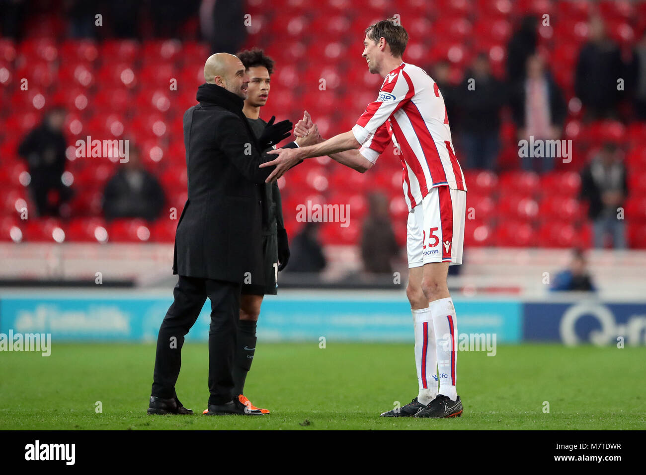 Stoke City's Peter Crouch (right) speaks with Manchester City manager ...