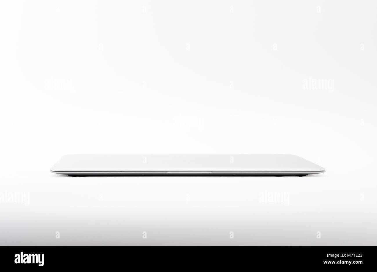 Closed modern, new laptop on white background, front view Stock Photo ...