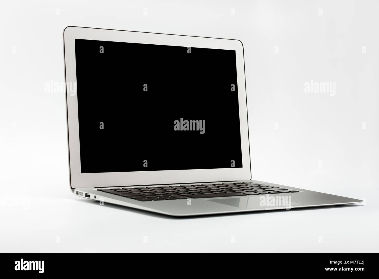 Modern new laptop on white background, side view, blank black desktop ...