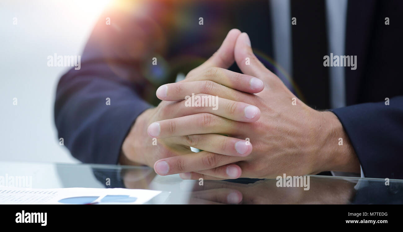 closeup.business man sitting behind a Desk Stock Photo - Alamy