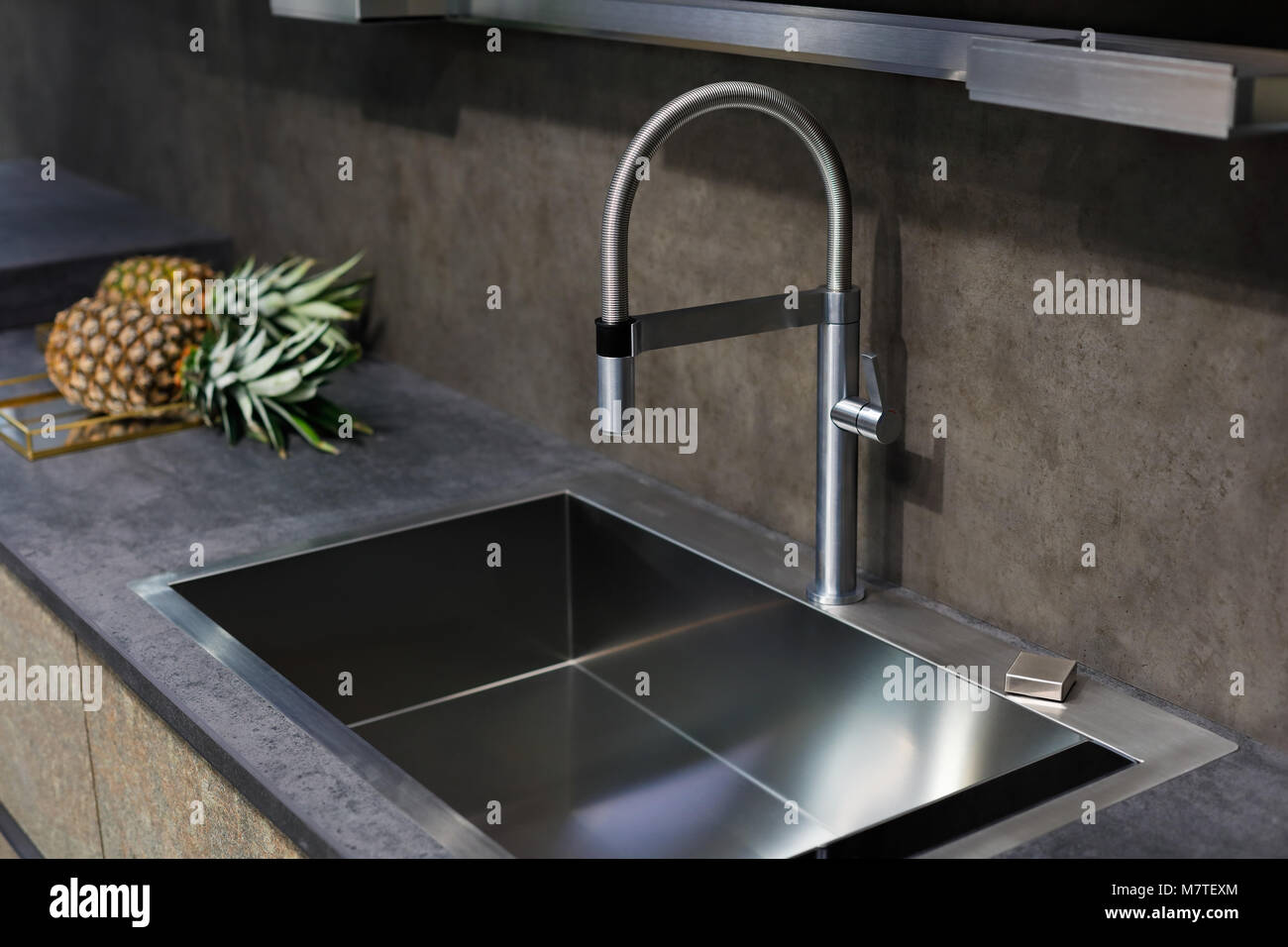 Stainless steel sink with a tap on a kitchen counter Stock Photo - Alamy