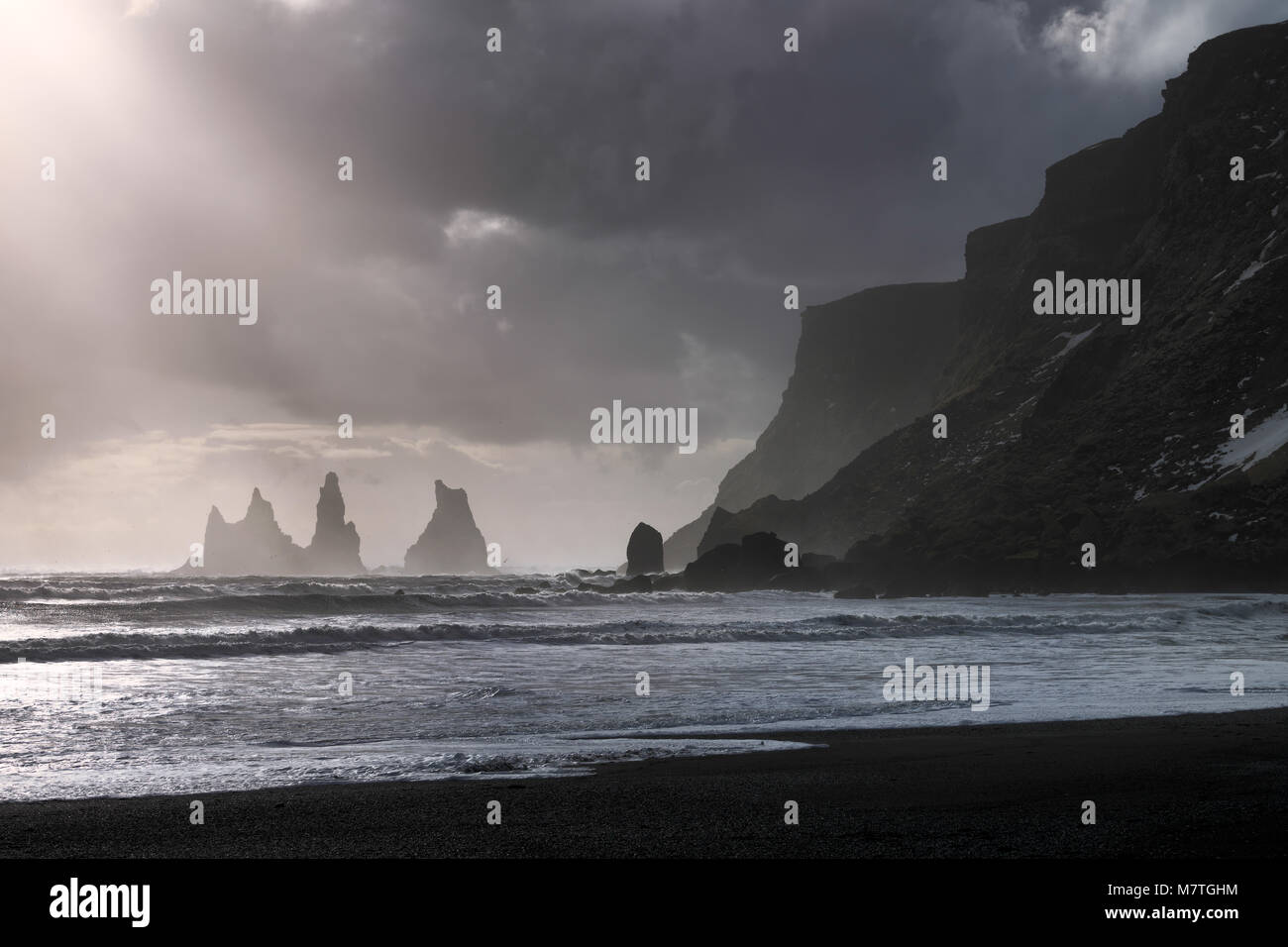 Reynisfjara black sand beach and Reynisdrangar basalt sea stacks as ...