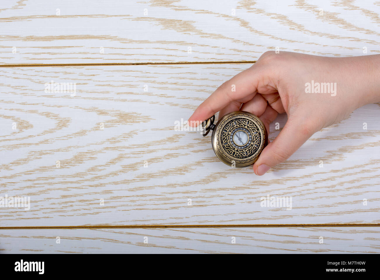 Retro style pocket watch in hand on black background Stock Photo - Alamy