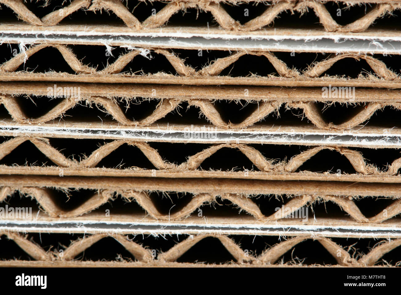 A Stacked corrugated cardboard boxes macro background Stock Photo - Alamy