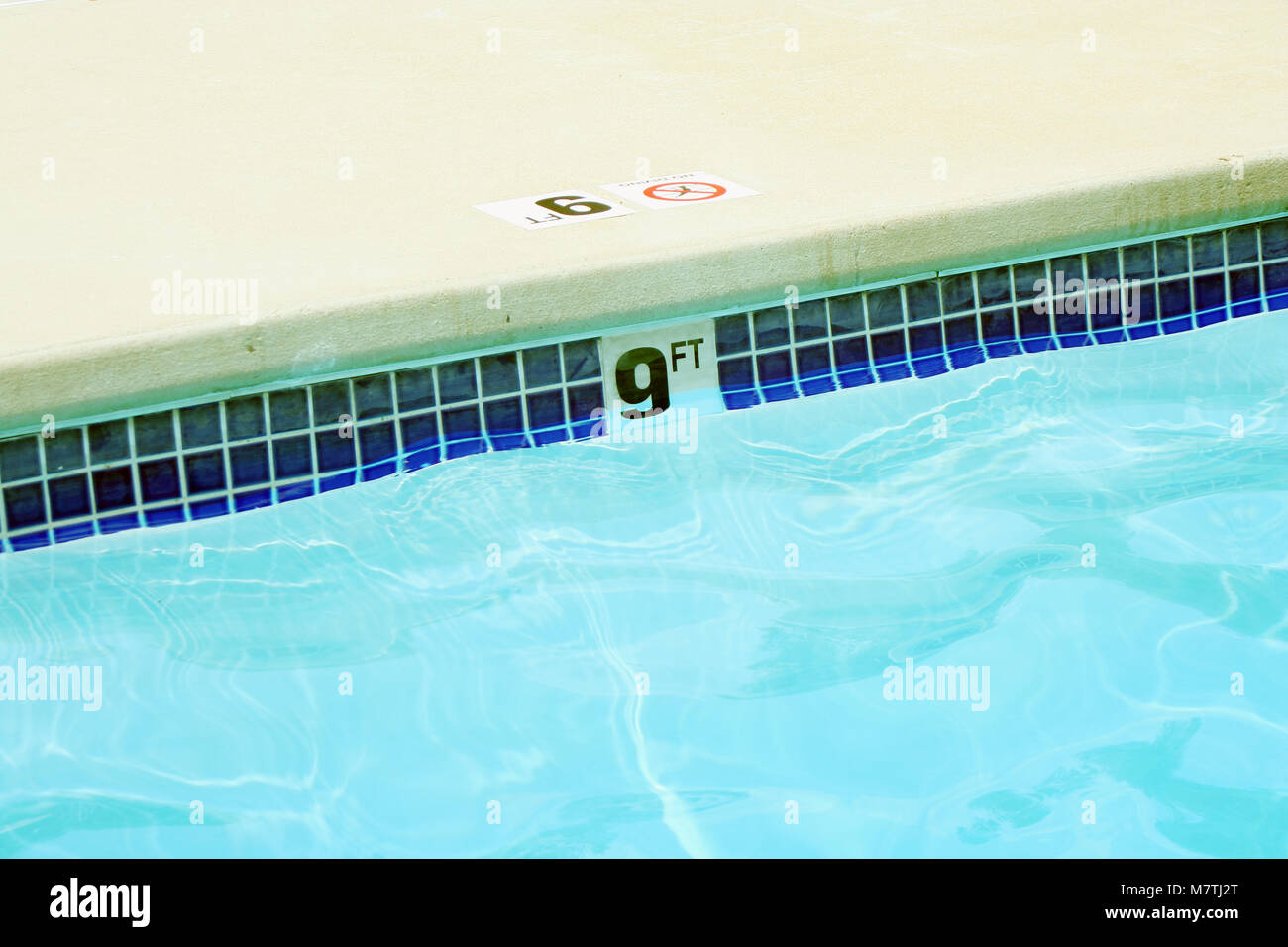 A Nine foot swimming pool water marker Stock Photo - Alamy