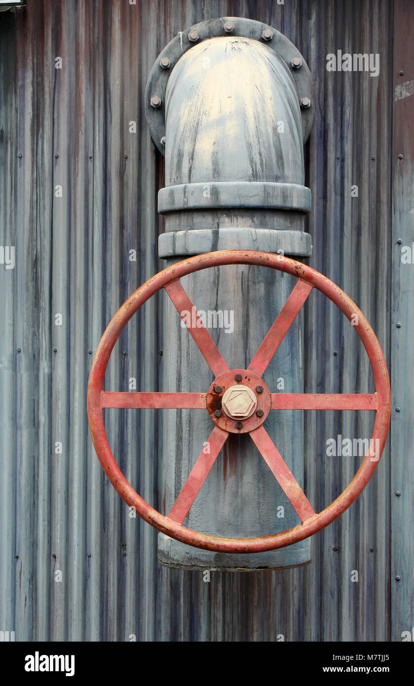 A Large red wheel valve with pipe Stock Photo - Alamy