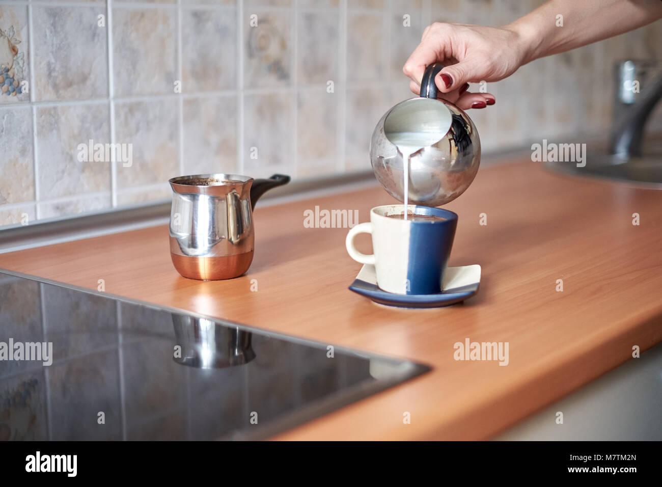 Cooking coffee in traditional copper turkey on a stove - kitchen ...