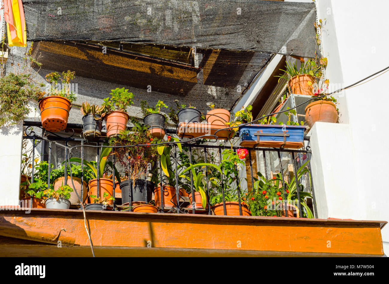Stylish balcony with a metal railing, solid architectural element, a ...