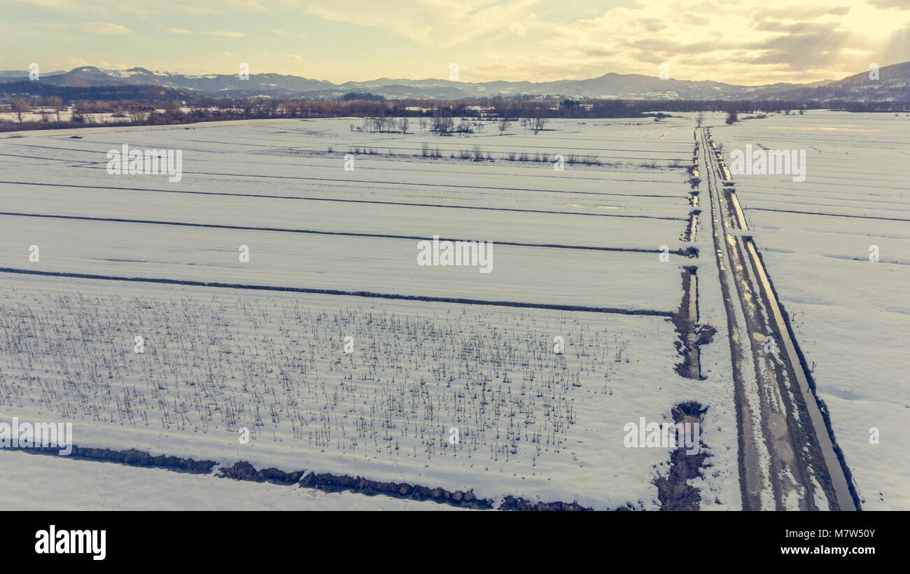 Aerial view of snow covered field road Stock Photo - Alamy