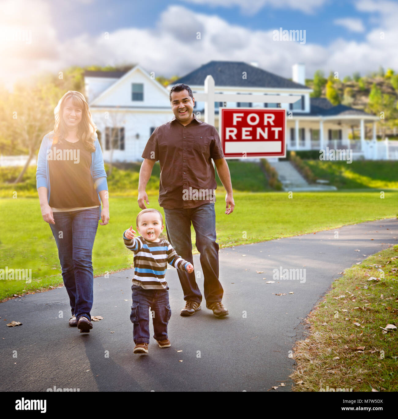 Happy Mixed Race Family Walking in Front of Home and For Rent Real ...